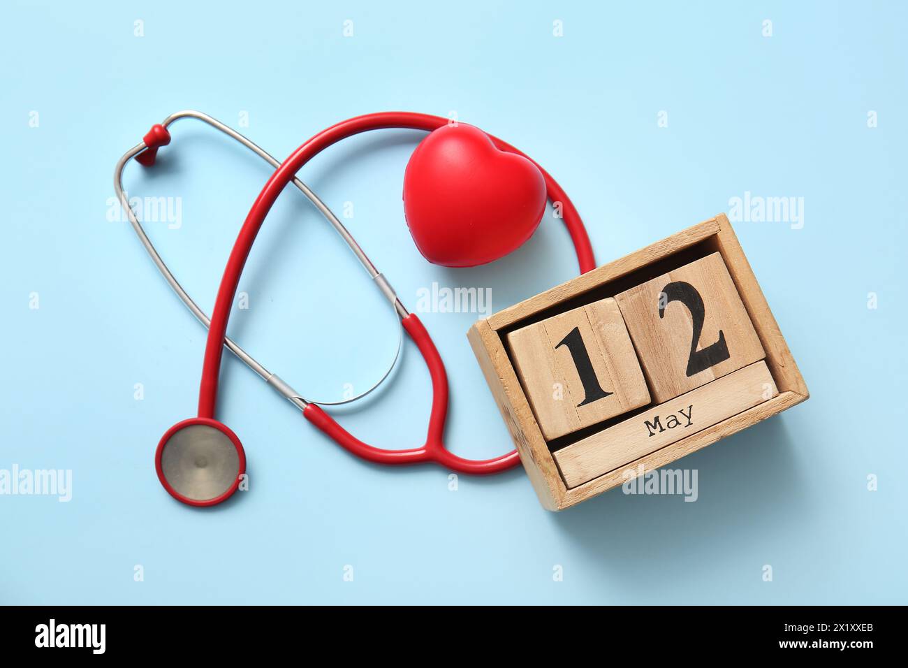 Calendar with heart and stethoscope on blue background. International ...