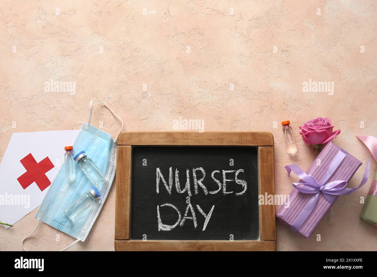 Chalkboard with text NURSES DAY, gift box and ampules on beige grunge ...