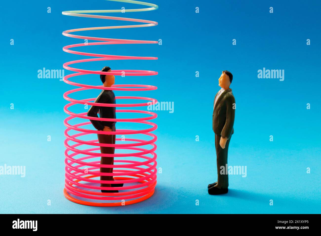Two men gathered where one of them is isolated inside a cylindrical ...