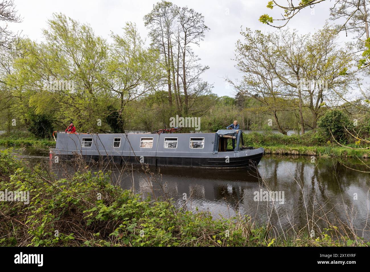London, UK. 16th April, 2024. Two people on a narrowboat navigate a ...