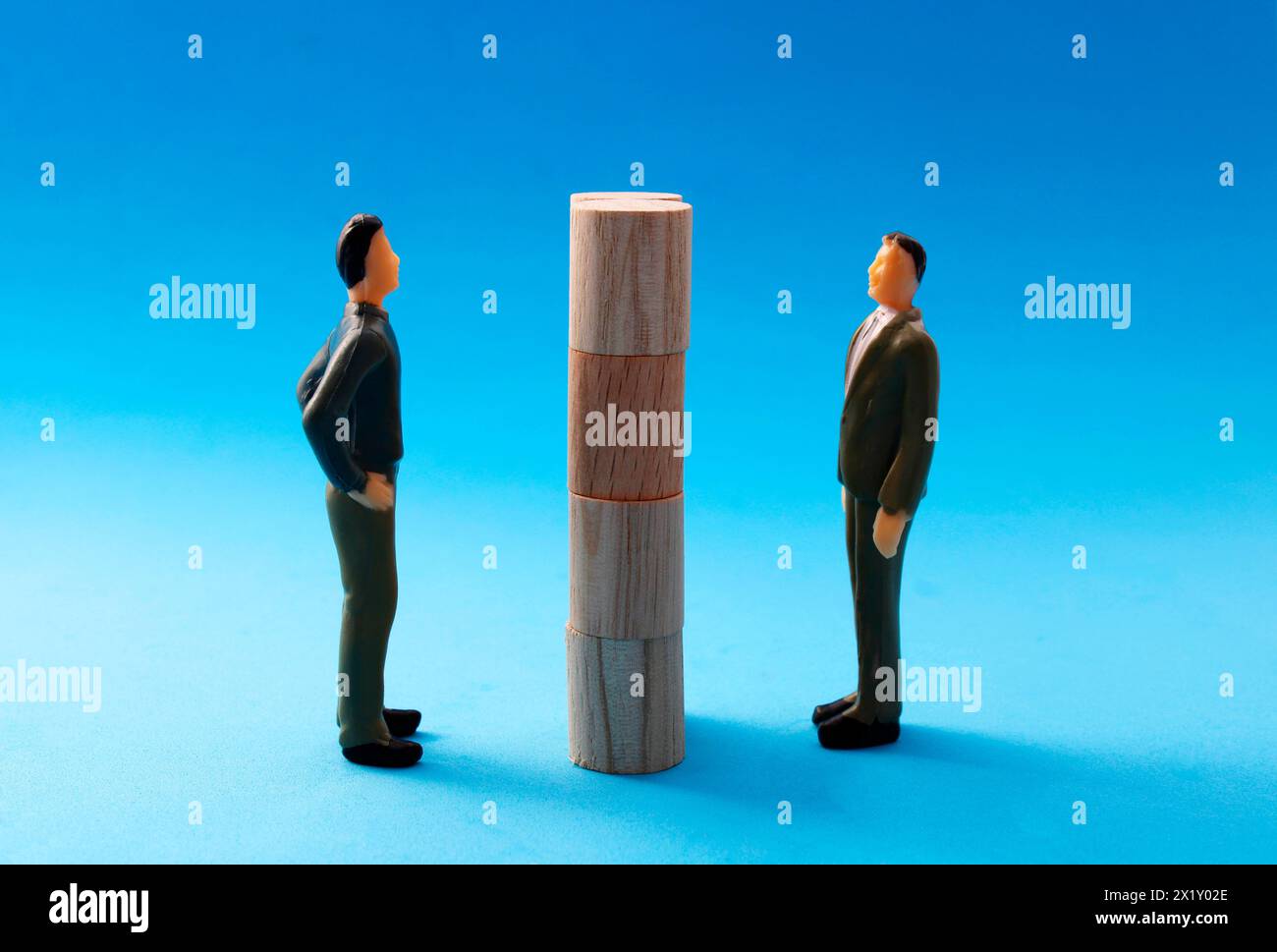 Two men separated by a barrier formed with wooden cylinders (plastic ...