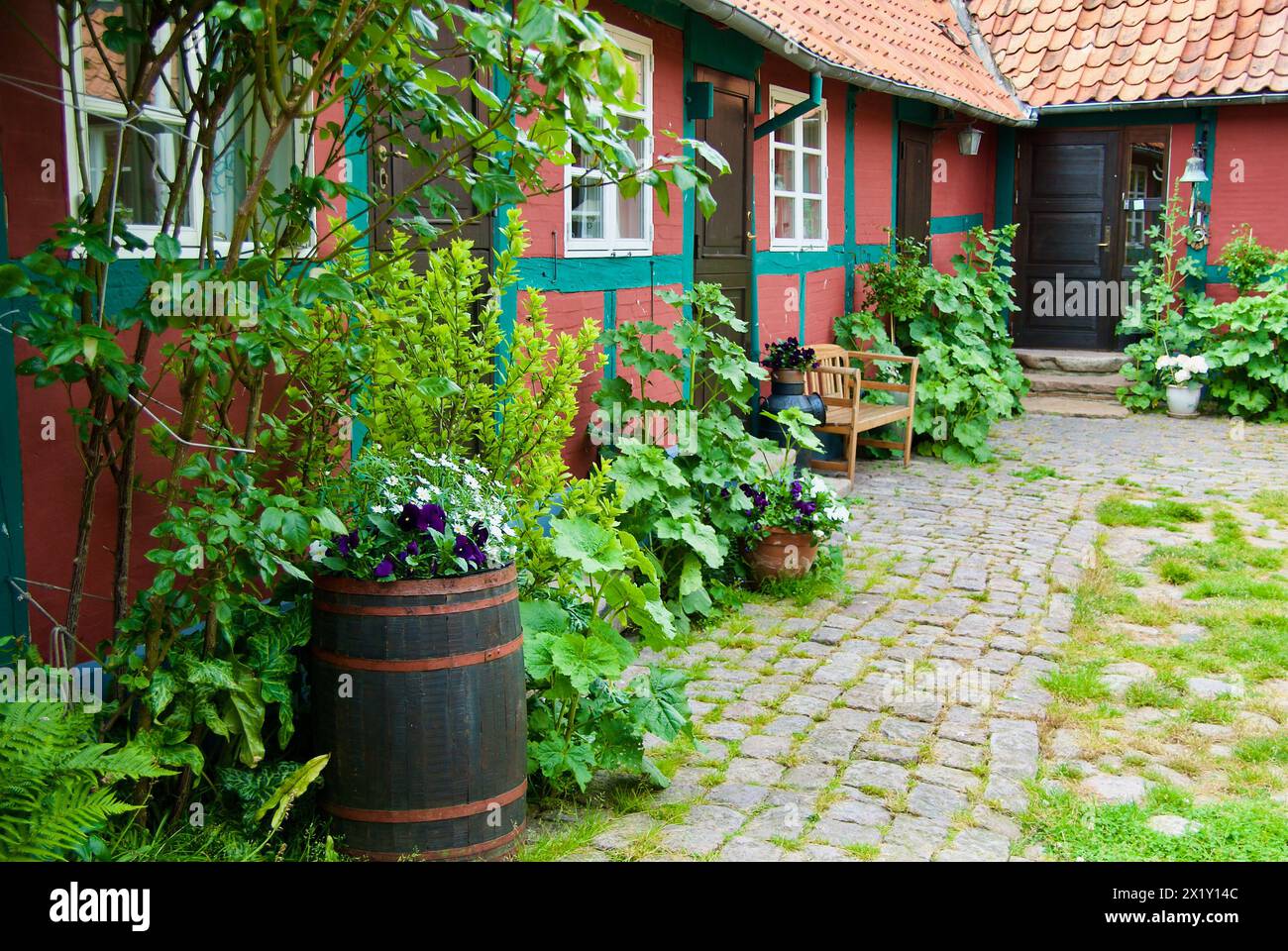A danish half-timbered townhouse with a lush inner garden and a path ...
