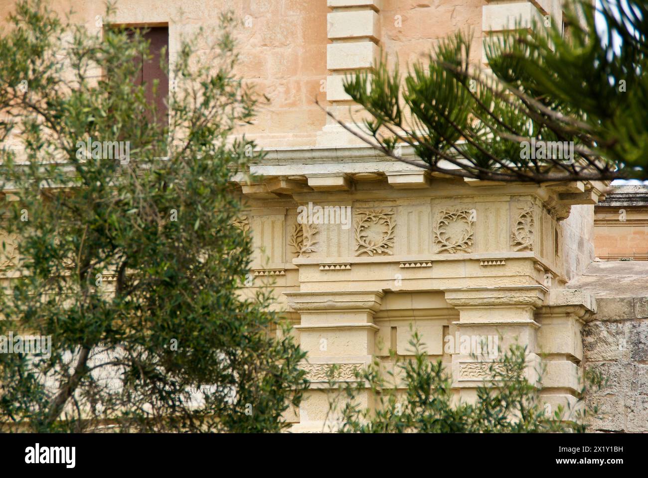 Historic palace with exquisite ornamentation behind olive trees in the ...