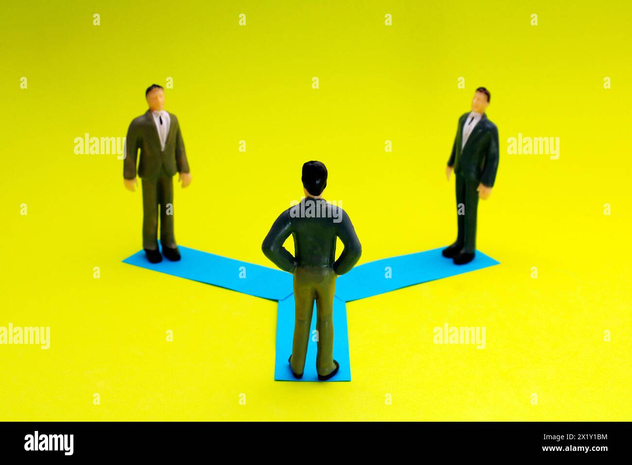 Three men taking different paths with a meeting point (plastic human ...