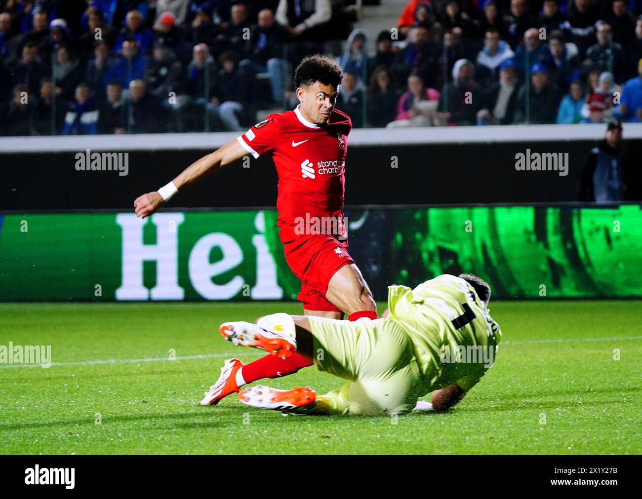 Atalanta goalkeeper Juan Musso saves at the feet of Liverpool's Luis ...