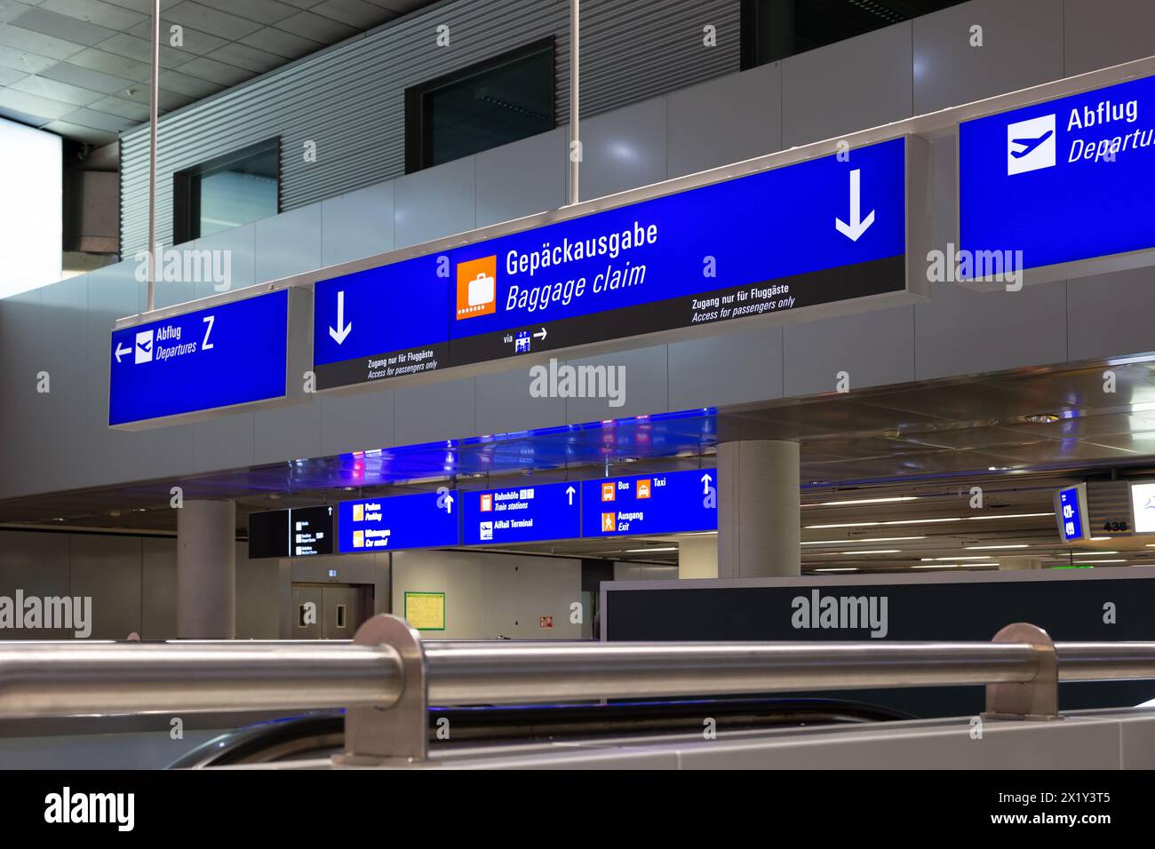 A blue information board in an airport terminal with arrows indicating ...
