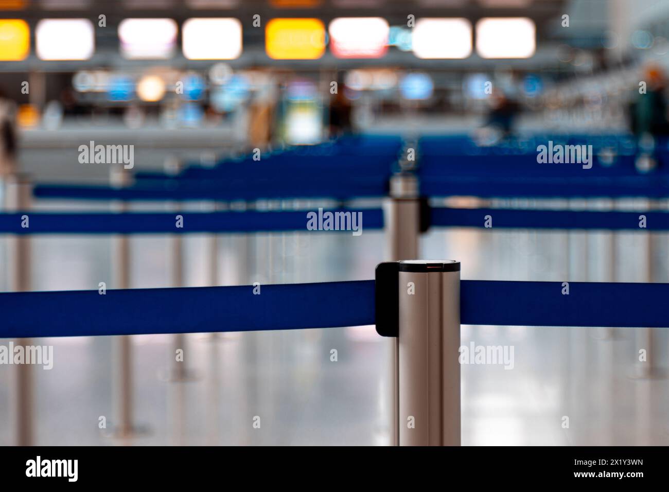 Close-up of a metallic barrier pole with blue retractable belts with ...
