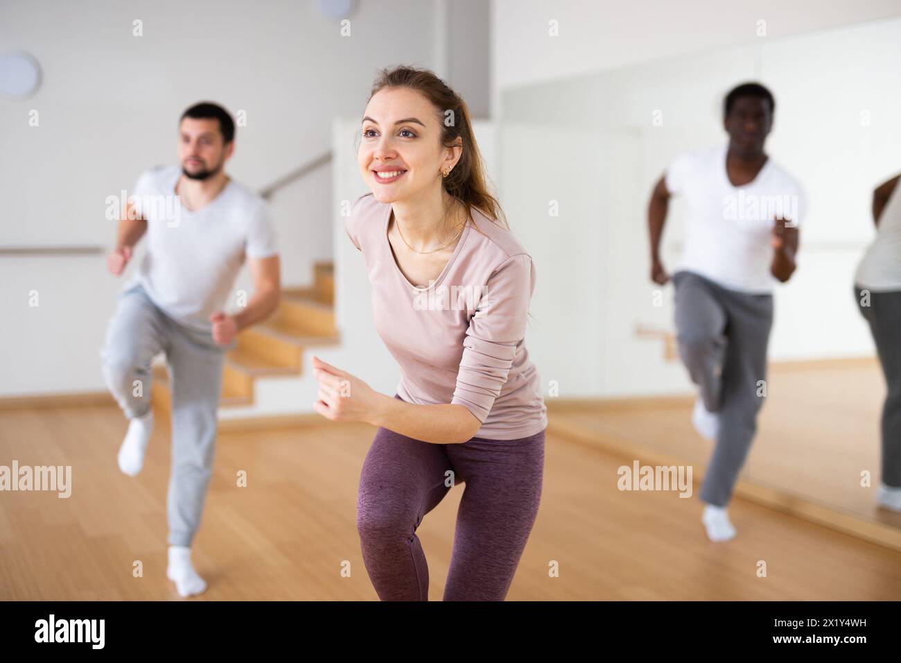 Cheerful woman dancing aerobic dance during group training Stock Photo ...