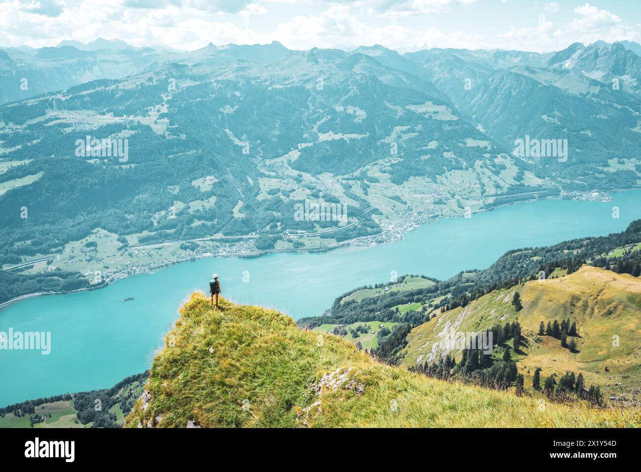Description: An athletic woman enjoys the panoramic view on Walensee ...