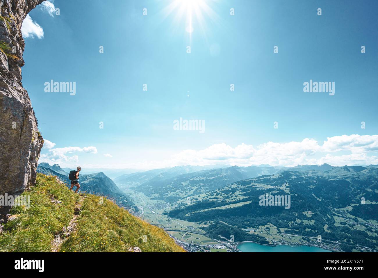 Description: Mountaineer at hike trail on steep slope enjoys amazing ...