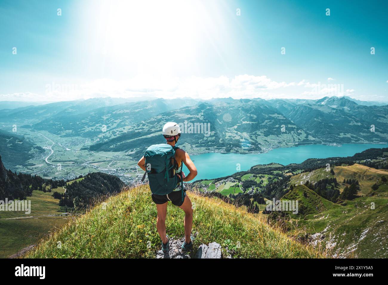 Description: Athletic woman enjoys the panoramic view on Walensee from ...