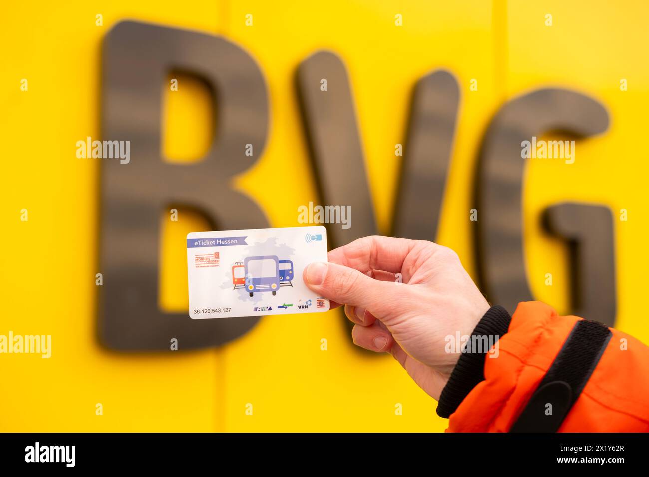 male hand hold electronic Deutschland-Ticket, BVG logo Berliner ...