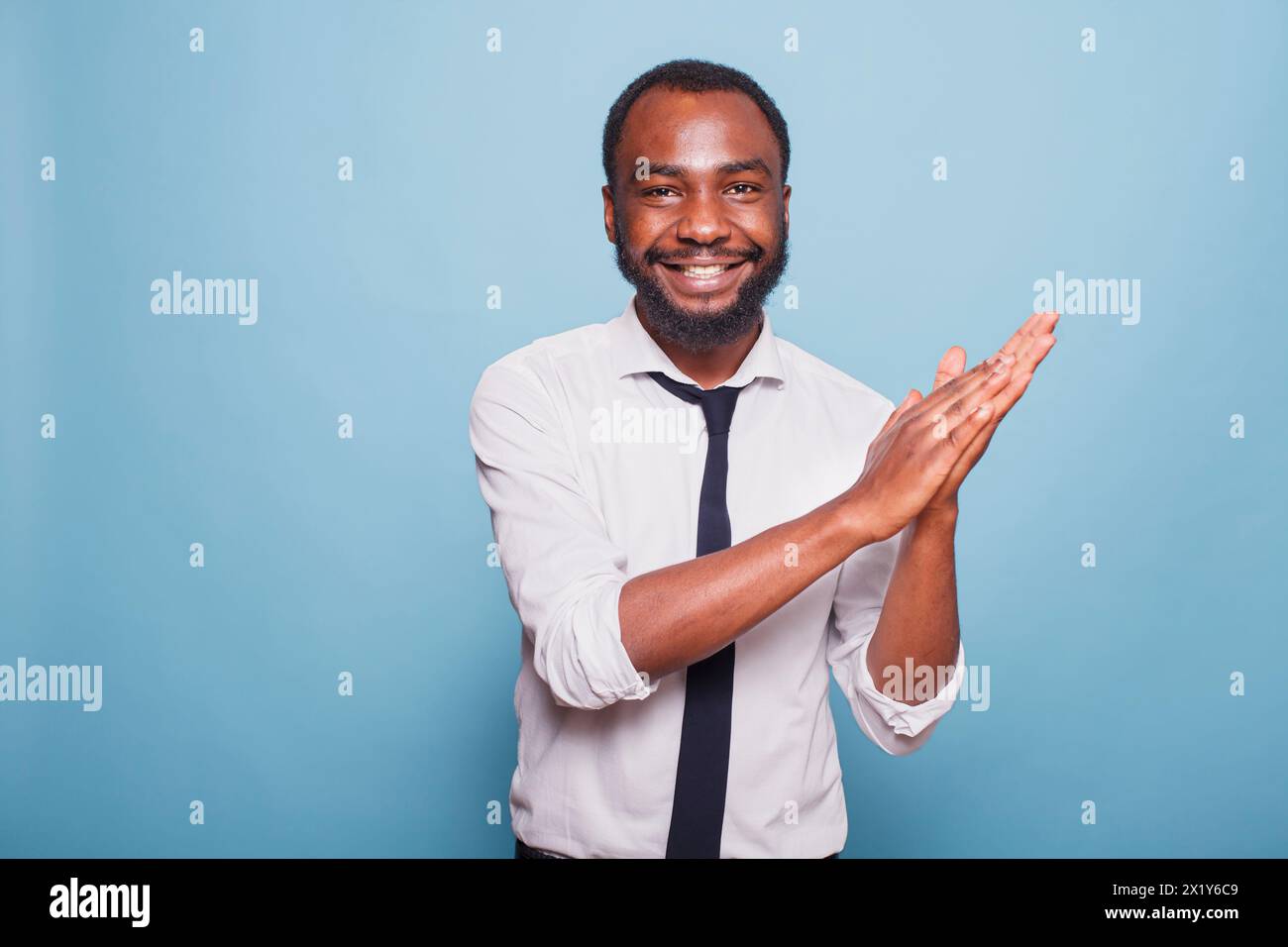 Smiling male adult clapping hands and cheering on job well done ...