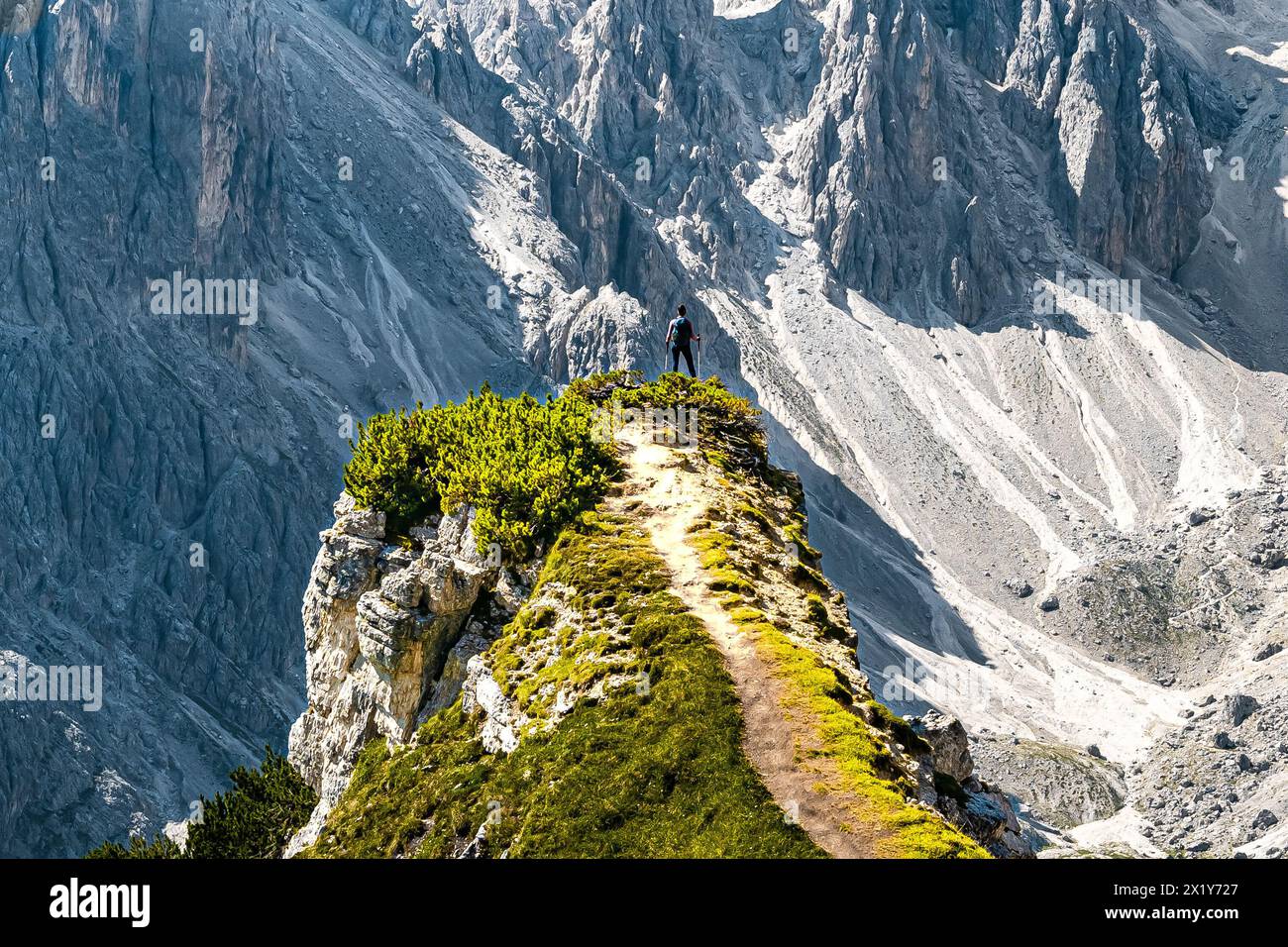 Description: Athletic woman walks on super epic view point with Cadini ...