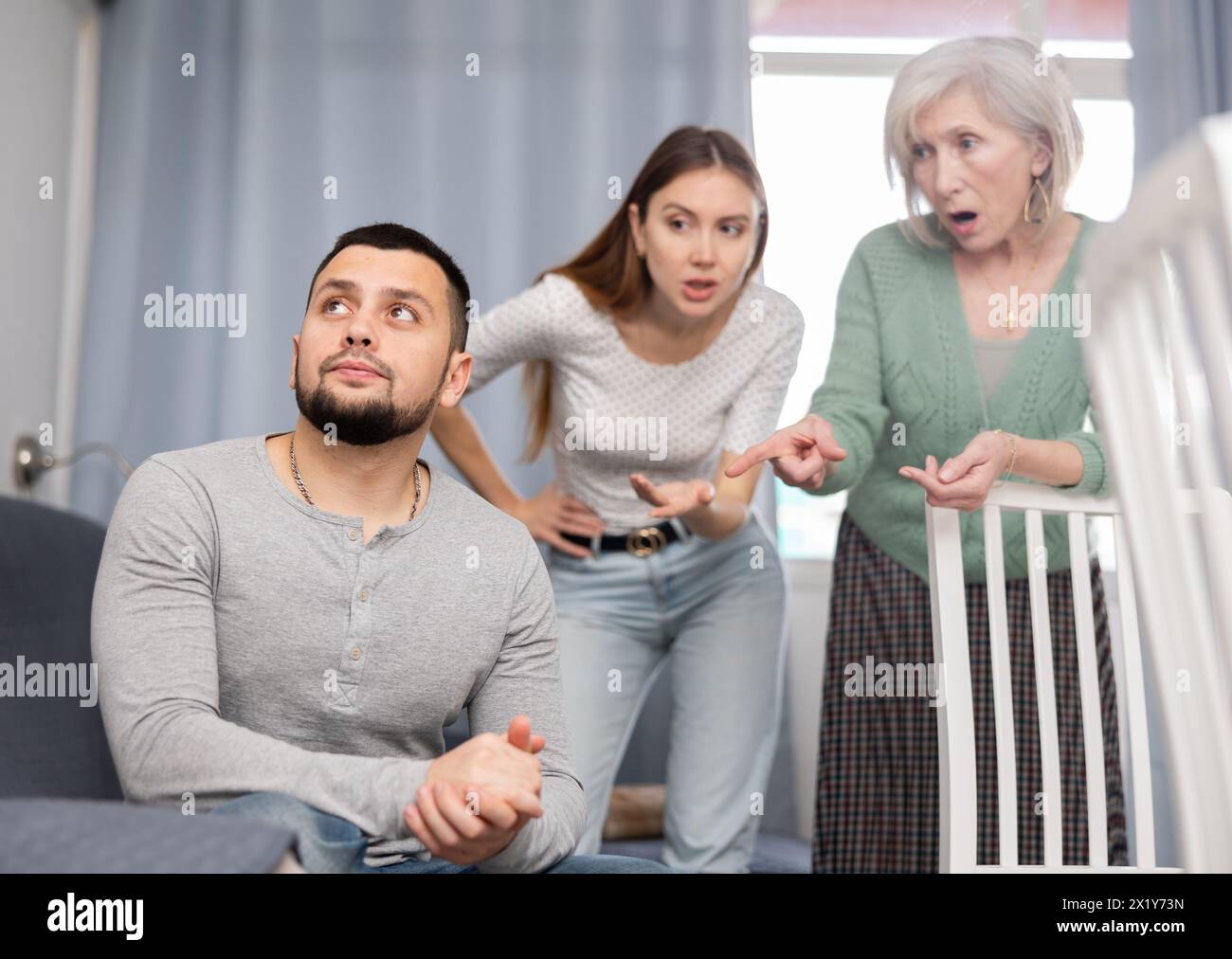 Man dont speaking after discord with mother and wife standing behind ...
