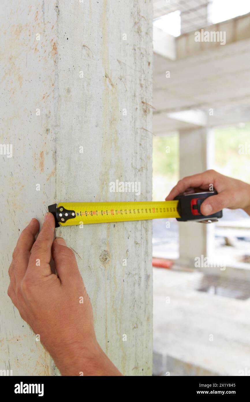 Taking measures in concrete beam, retractable tape, housing ...