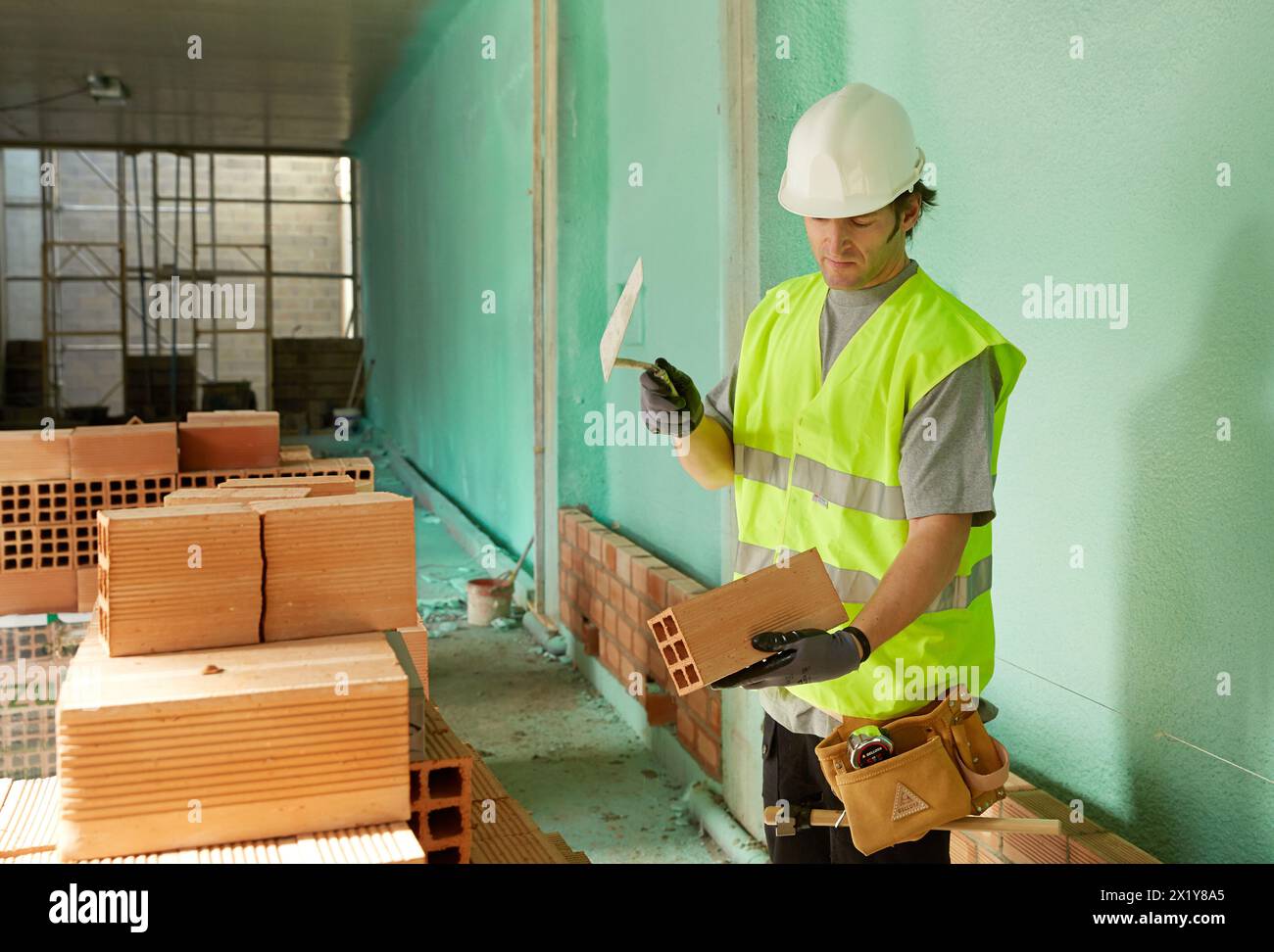 Bricklayer with trowel making a brick wall, Mason with personal ...