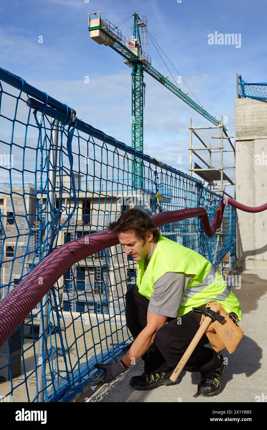 Mason placing security protection, Bricklayer with personal protective ...