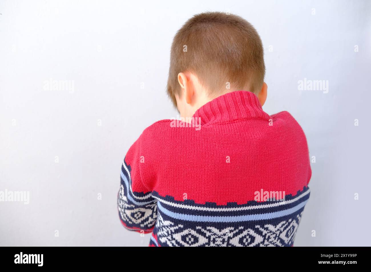 offended or punished child, a boy of 7-8 years old in a red ...