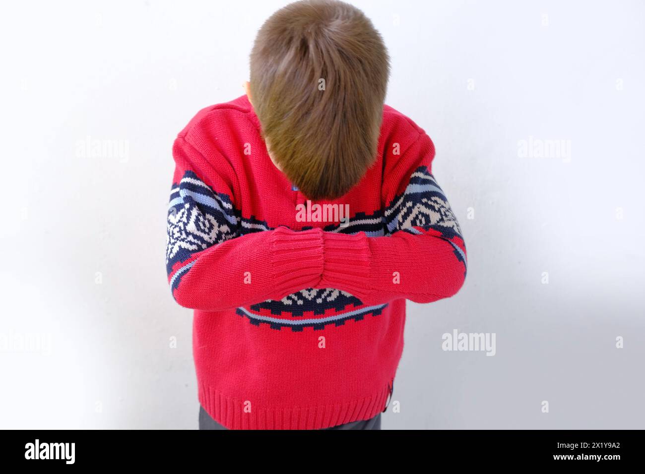 offended or punished child, a boy of 7-8 years old in a red ...