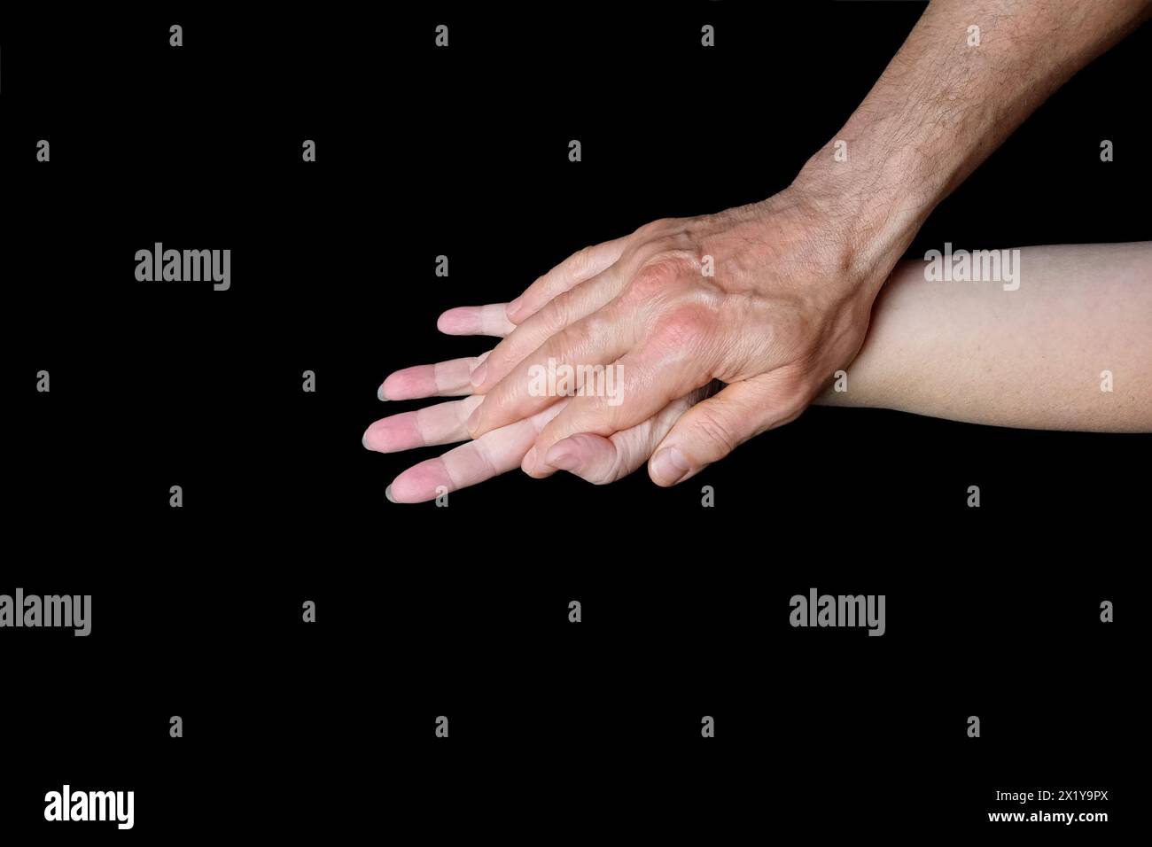 male and female hands together on black background, old skin with ...