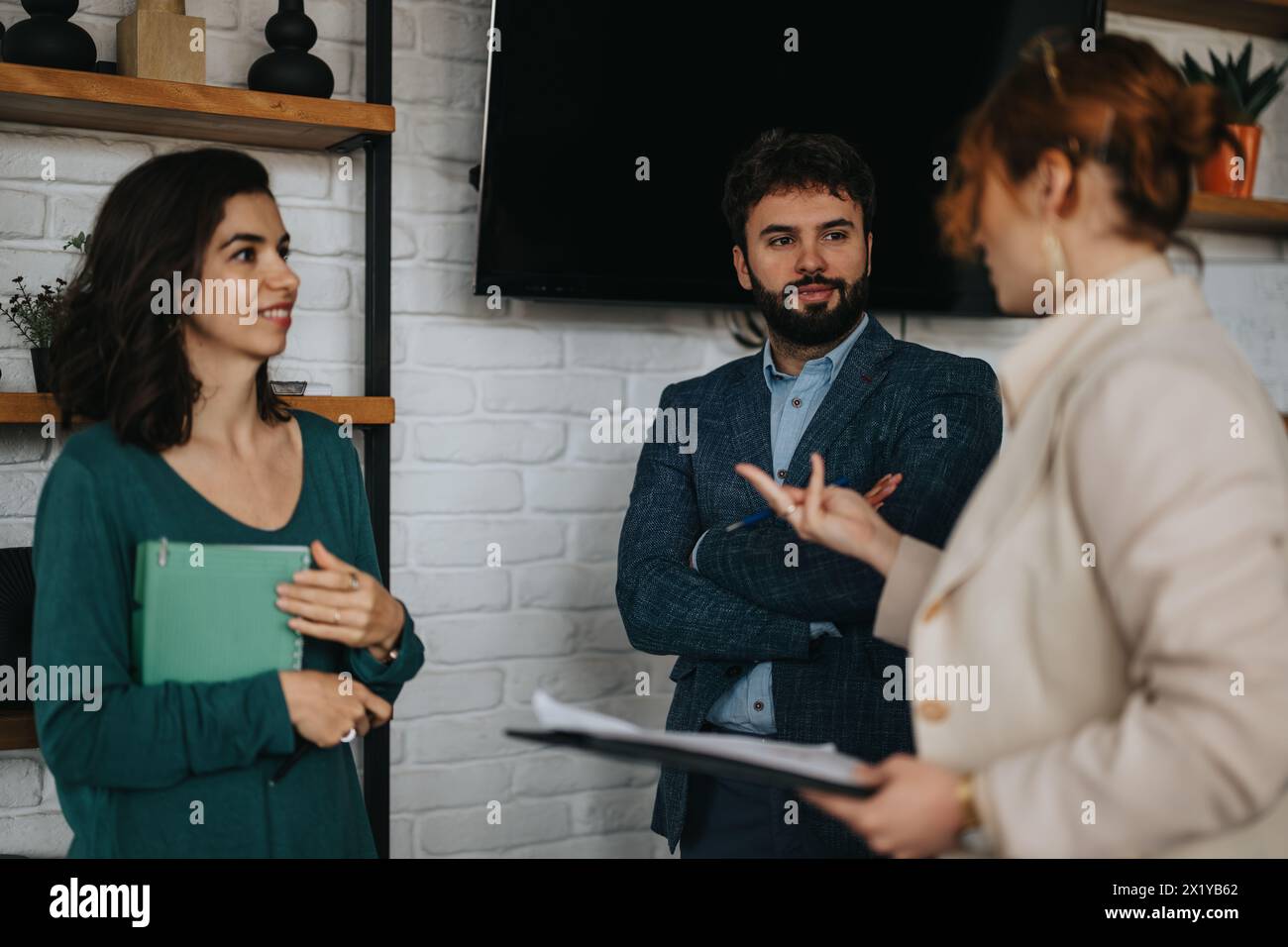 Creative team engaging in discussion during a casual office meeting ...