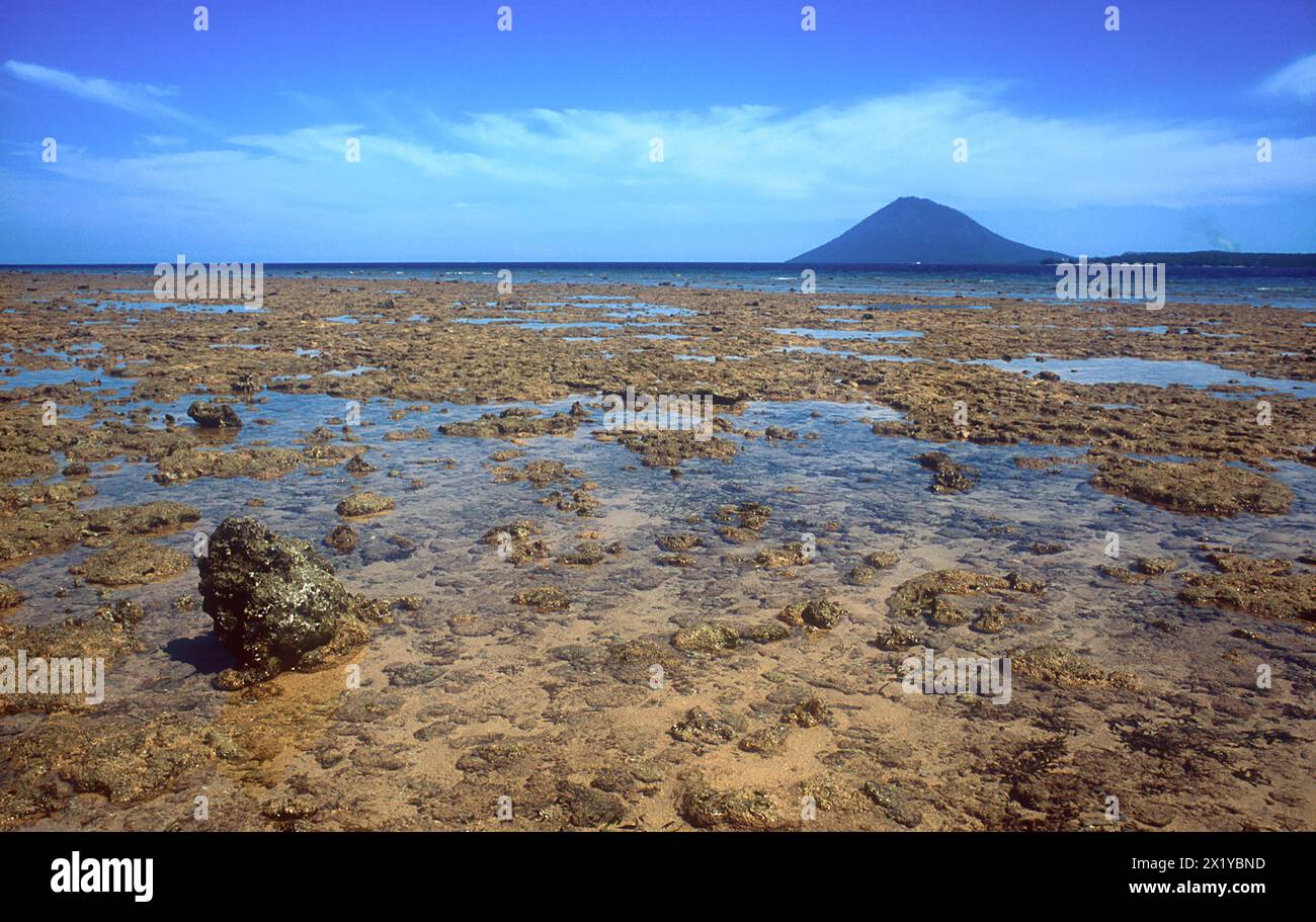 Reef at low tide with Manado Tua volcano island in background, Manado ...