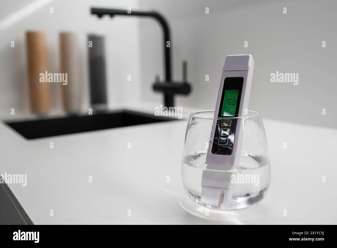 Conductometer shows that the tap water is clean, immersed into the ...