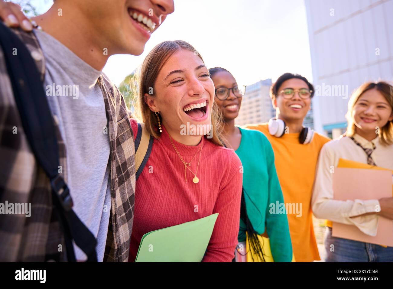 Laughing Caucasian female student with multiracial group of classmates ...