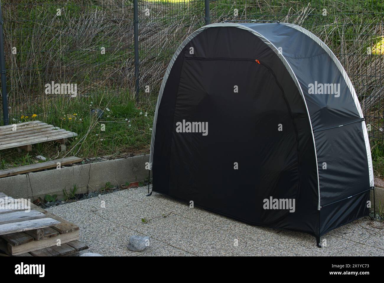 Closed black bicycle tent with a zipper closure, set outdoors Stock ...