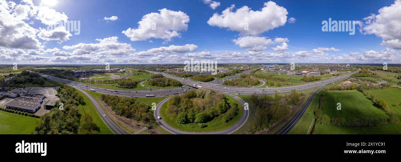 Aerial overview of dramatic clouds above transit roundabout Hoevelaken ...