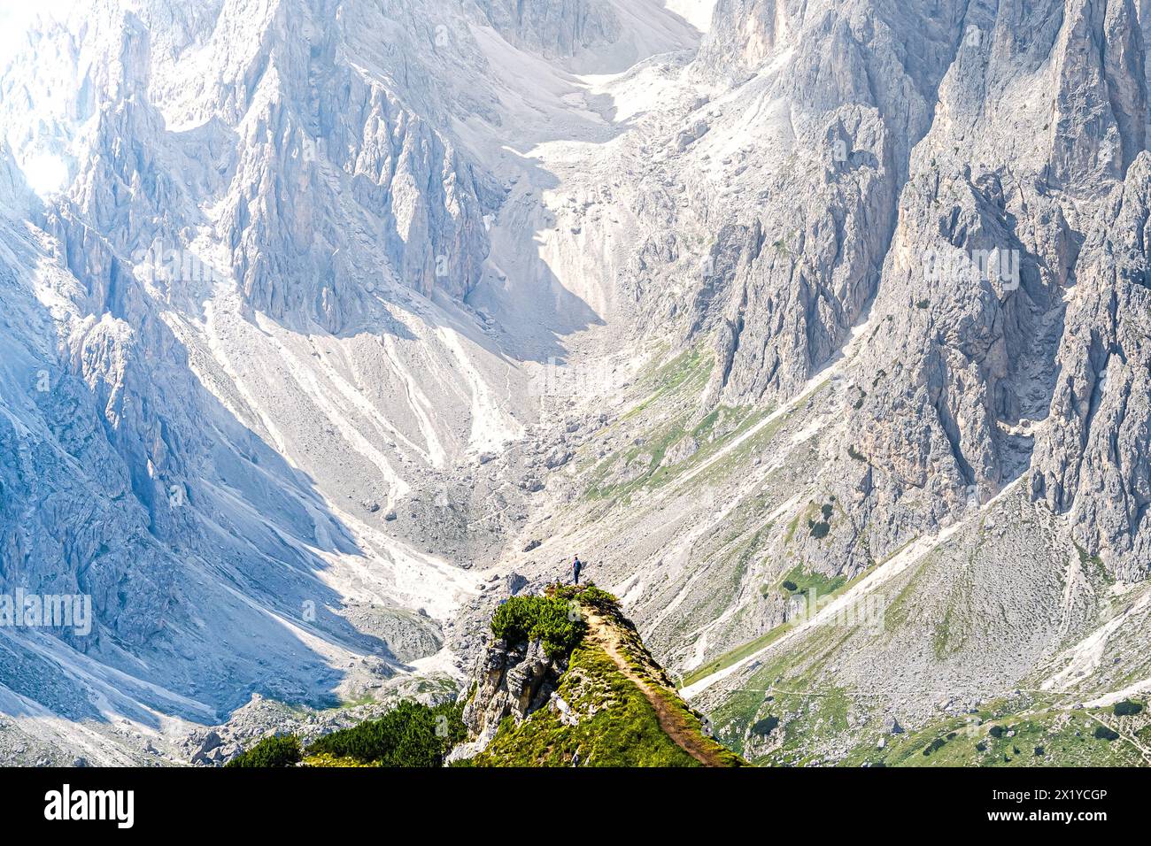 Description: Athletic woman walks on super epic view point with Cadini ...