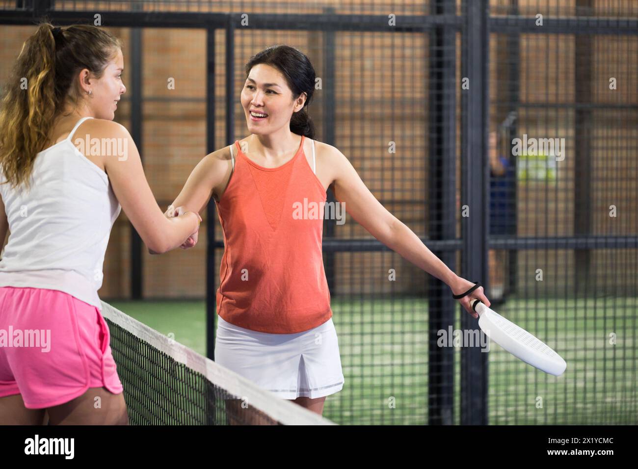 Woman padel player shaking hands to female opponent after match Stock ...