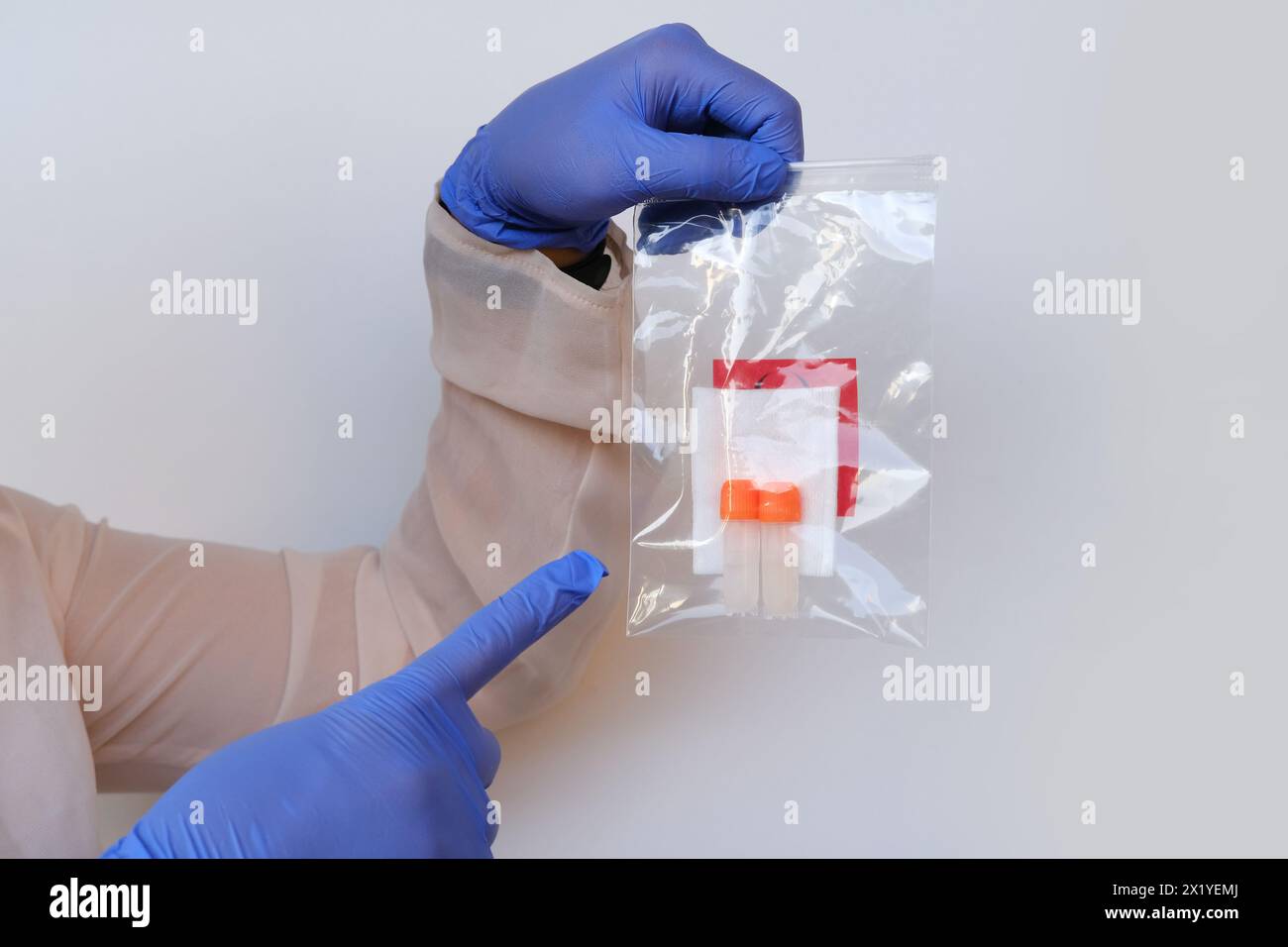 woman holding a kit for scraping the epithelium for dna test ...