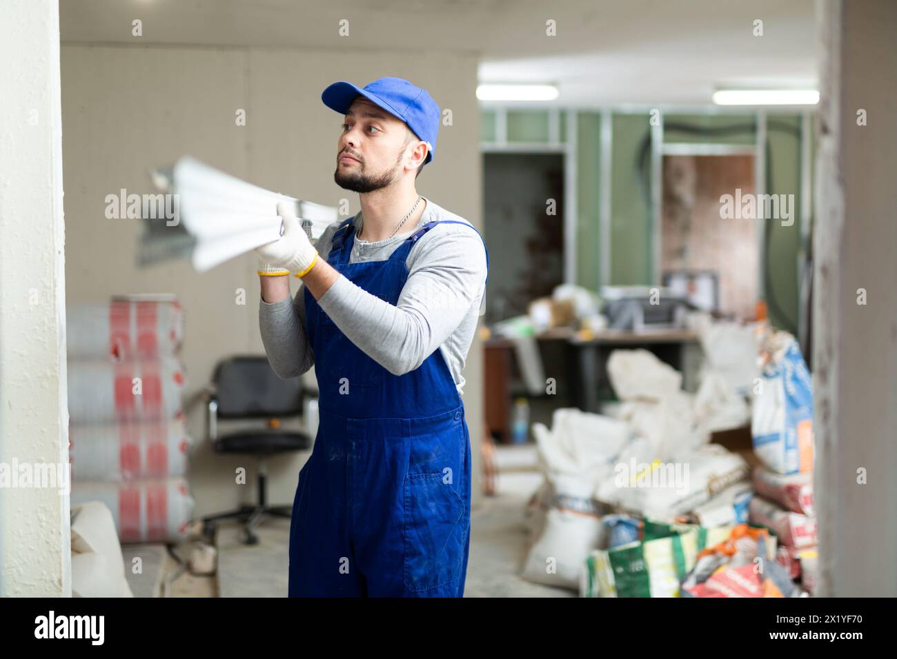 Worker carrying construction materials at renovating object Stock Photo ...