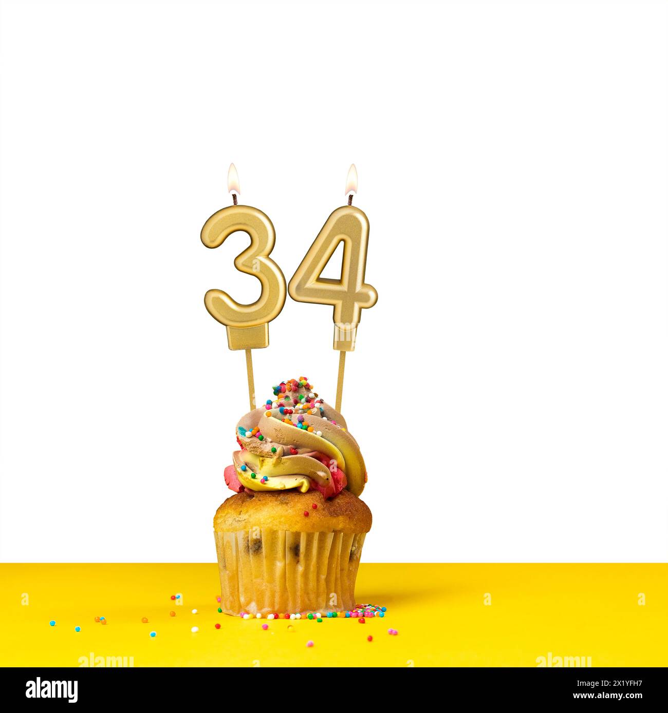 Birthday candle number 34 - Cupcake on white background Stock Photo - Alamy