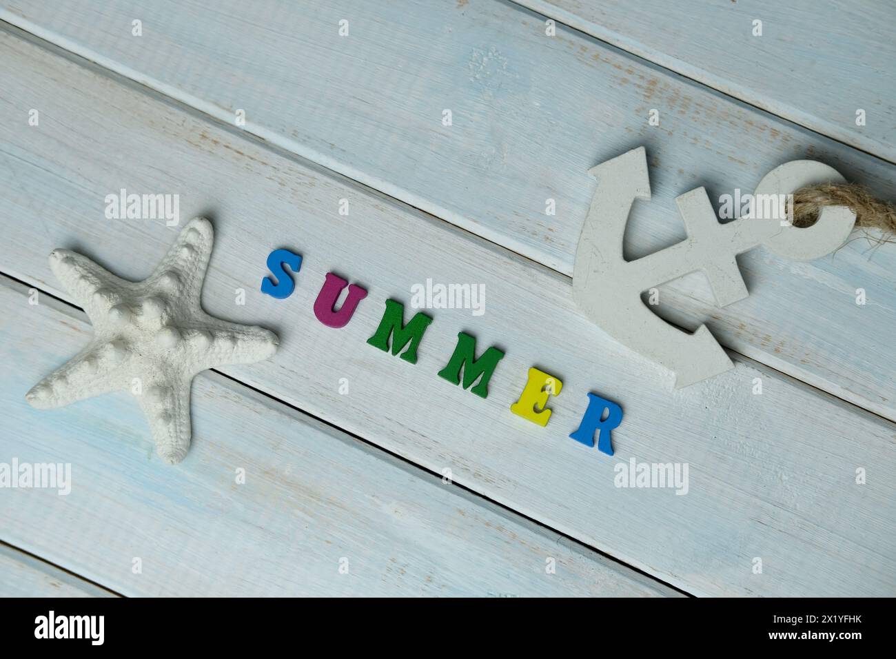 word summer is made up of volumetric colored letters on a light blue ...
