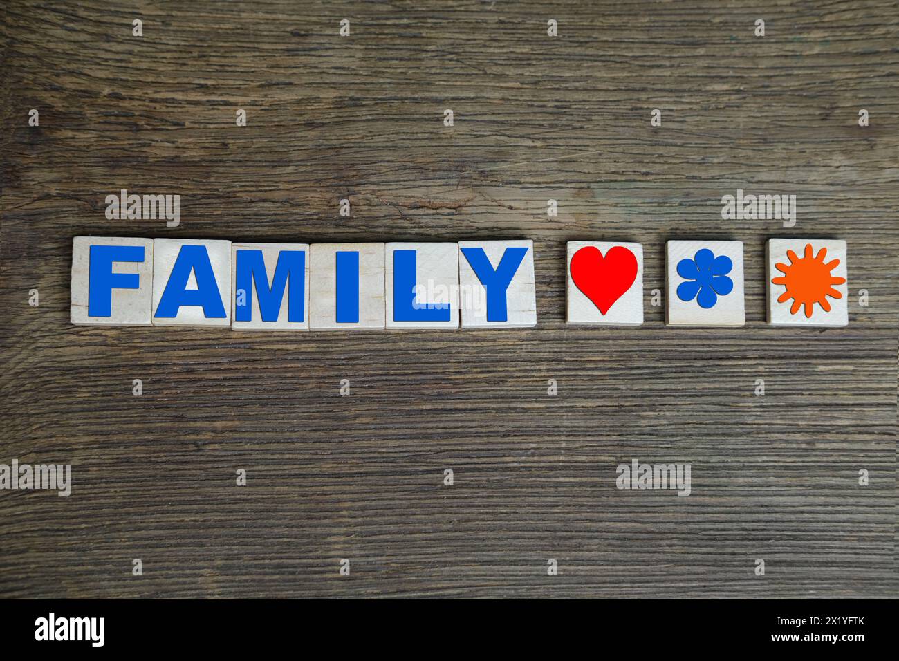 word family from volumetric colored letters on a dark wooden background ...