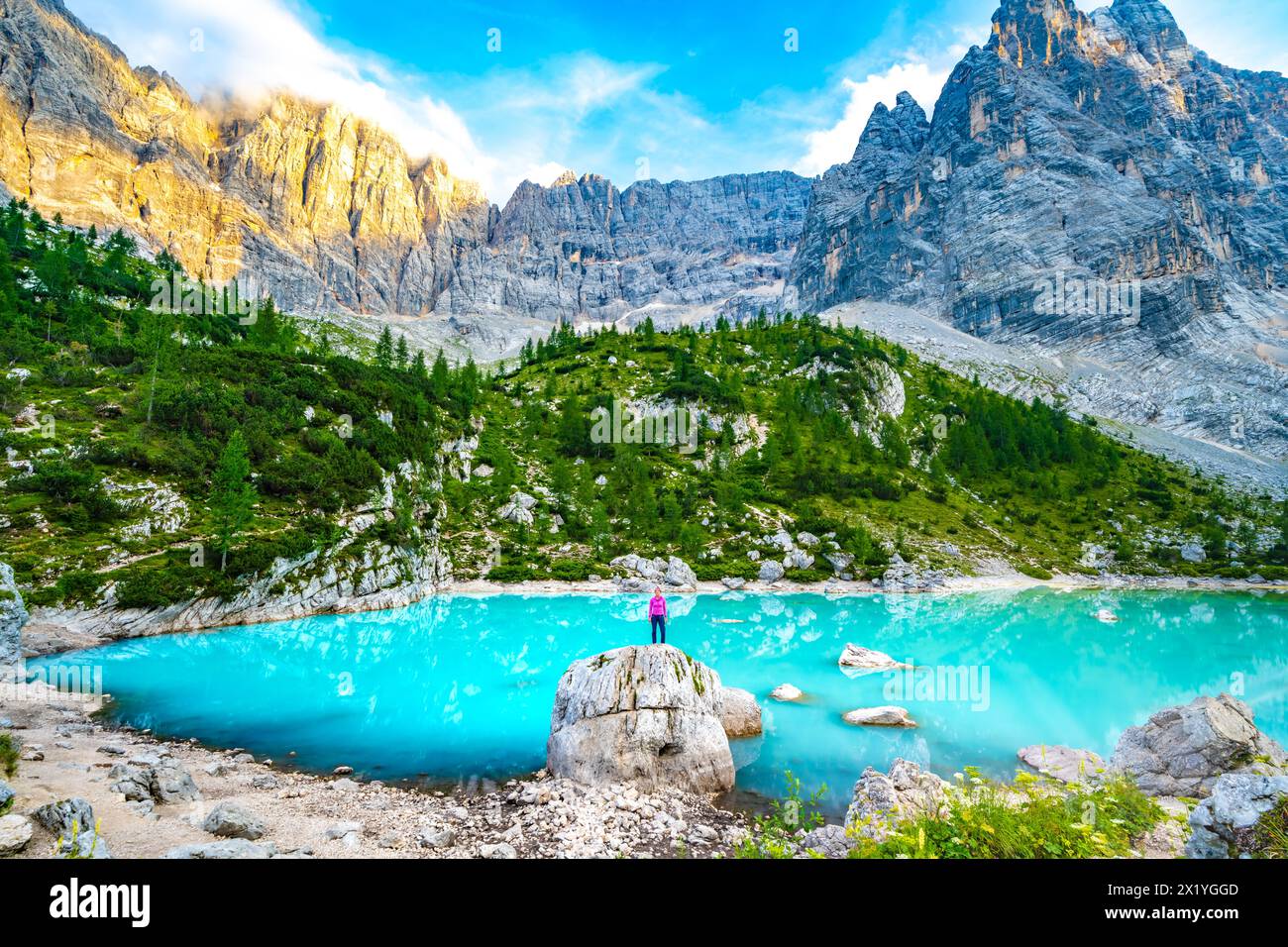 Description: Athletic woman enjoys beautiful view from huge boulder on ...