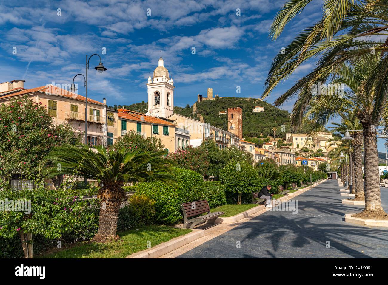 Palm trees of the waterfront and Noli Cathedral, Riviera di Ponente ...