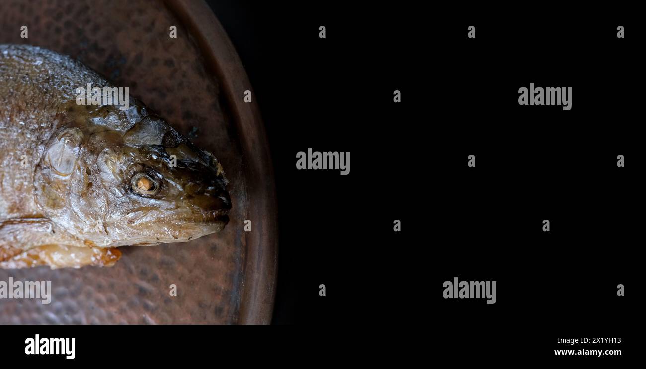 closeup fried river fish rainbow trout, Oncorhynchus mykiss lies on a ...