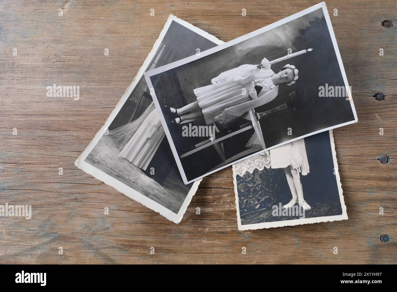 old vintage monochrome photographs in sepia color are scattered on a ...