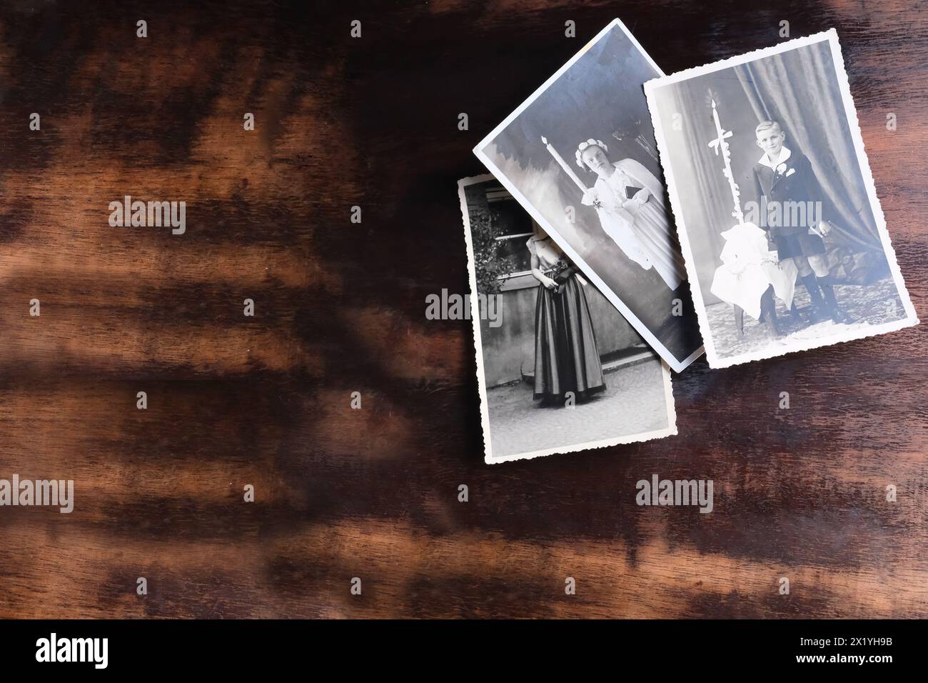 stack of old vintage photos of 1940-1950 in sepia color on a wooden ...