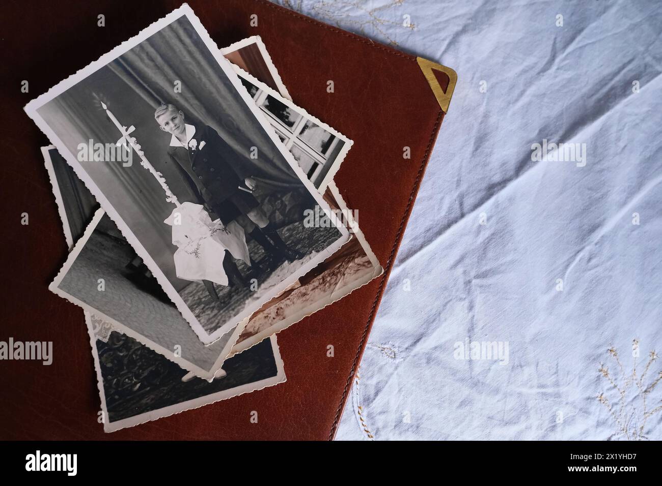 old photo albums lie on a white mint tablecloth, vintage photographs of ...