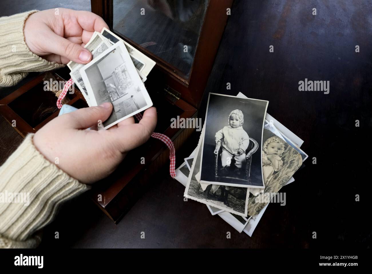 closeup female hand holding old vintage photos of 1940-1950, concept of ...