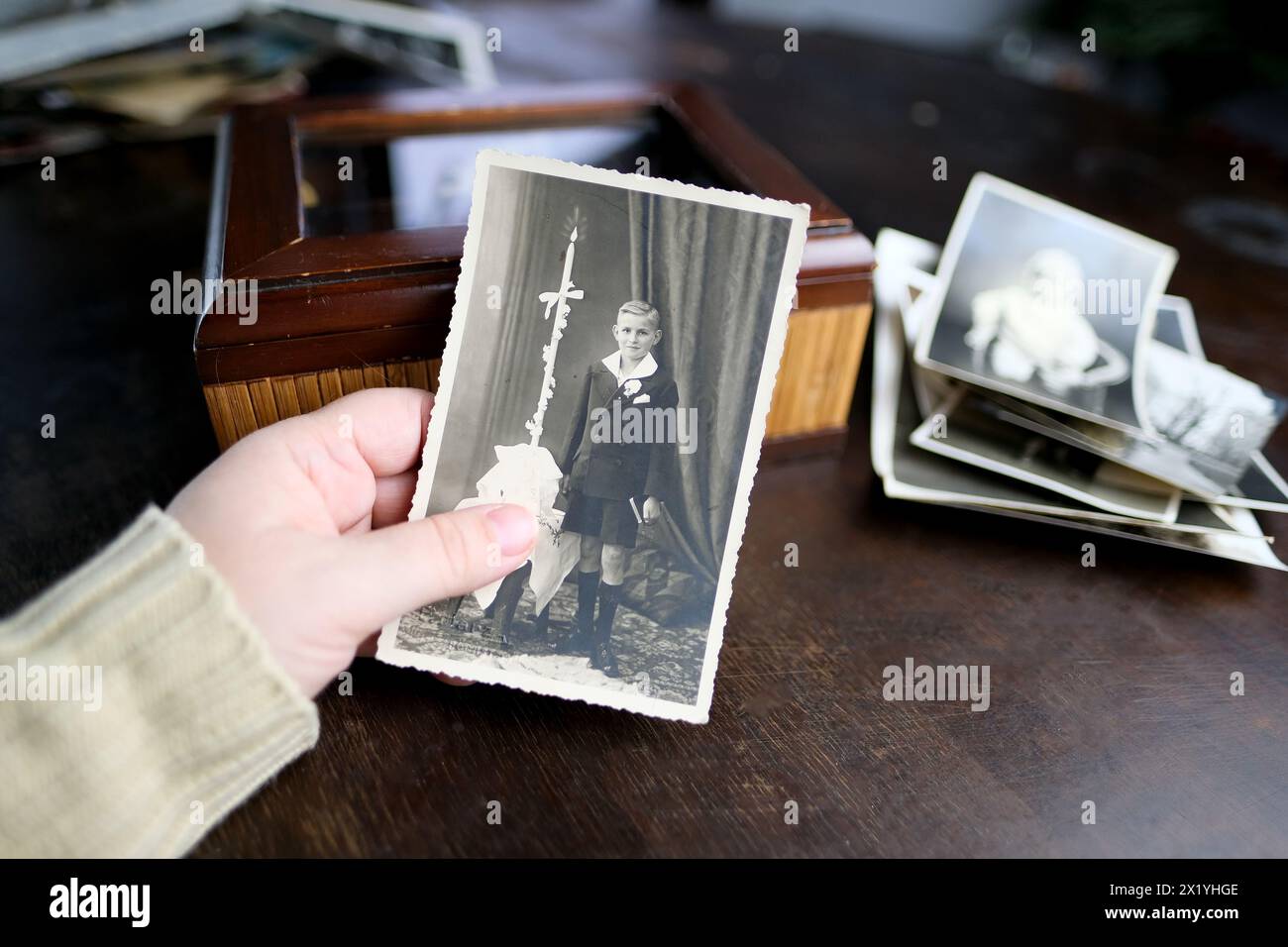 closeup female hand holding old vintage photos of 1940-1950, concept of ...
