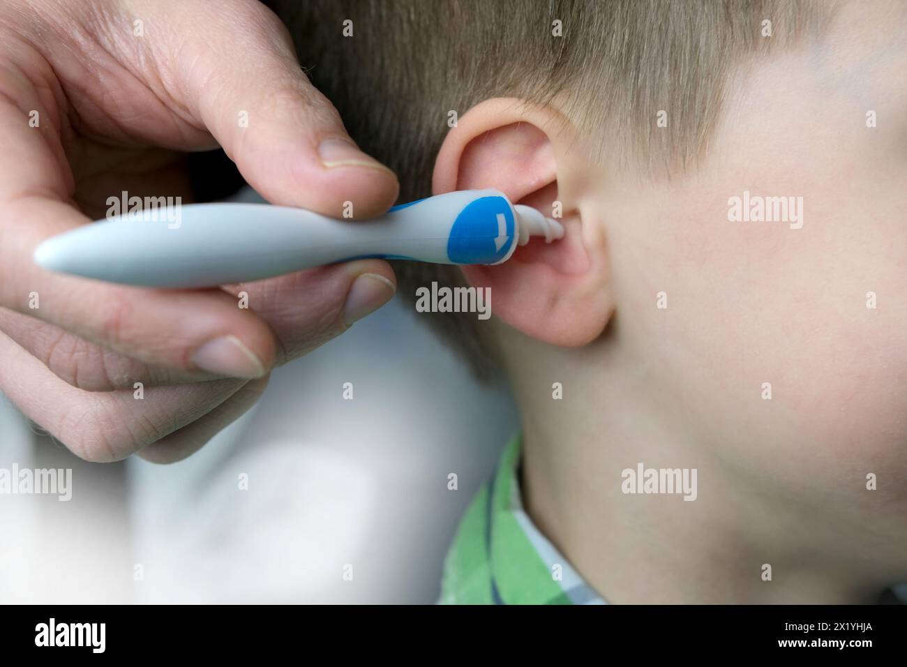 close-up ear child, kid, adult hand gently cleans the inner ear, Spiral ...