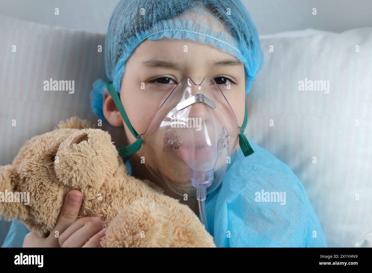 little patient in shirt, child, boy lies with teddy bear, facial oxygen ...