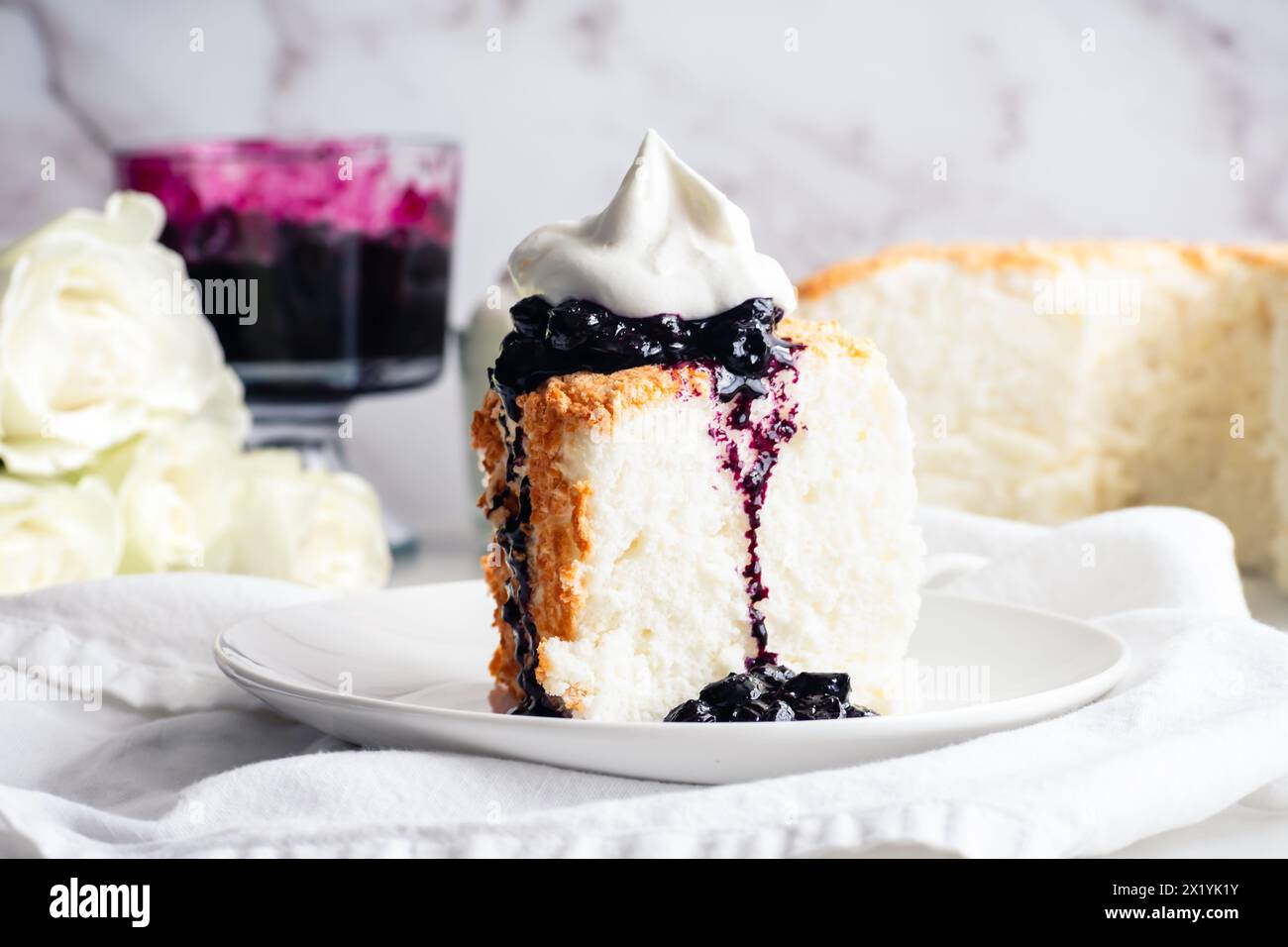 Angel Food Cake with Blueberry Sauce and Whipped Cream: Slice of sponge ...
