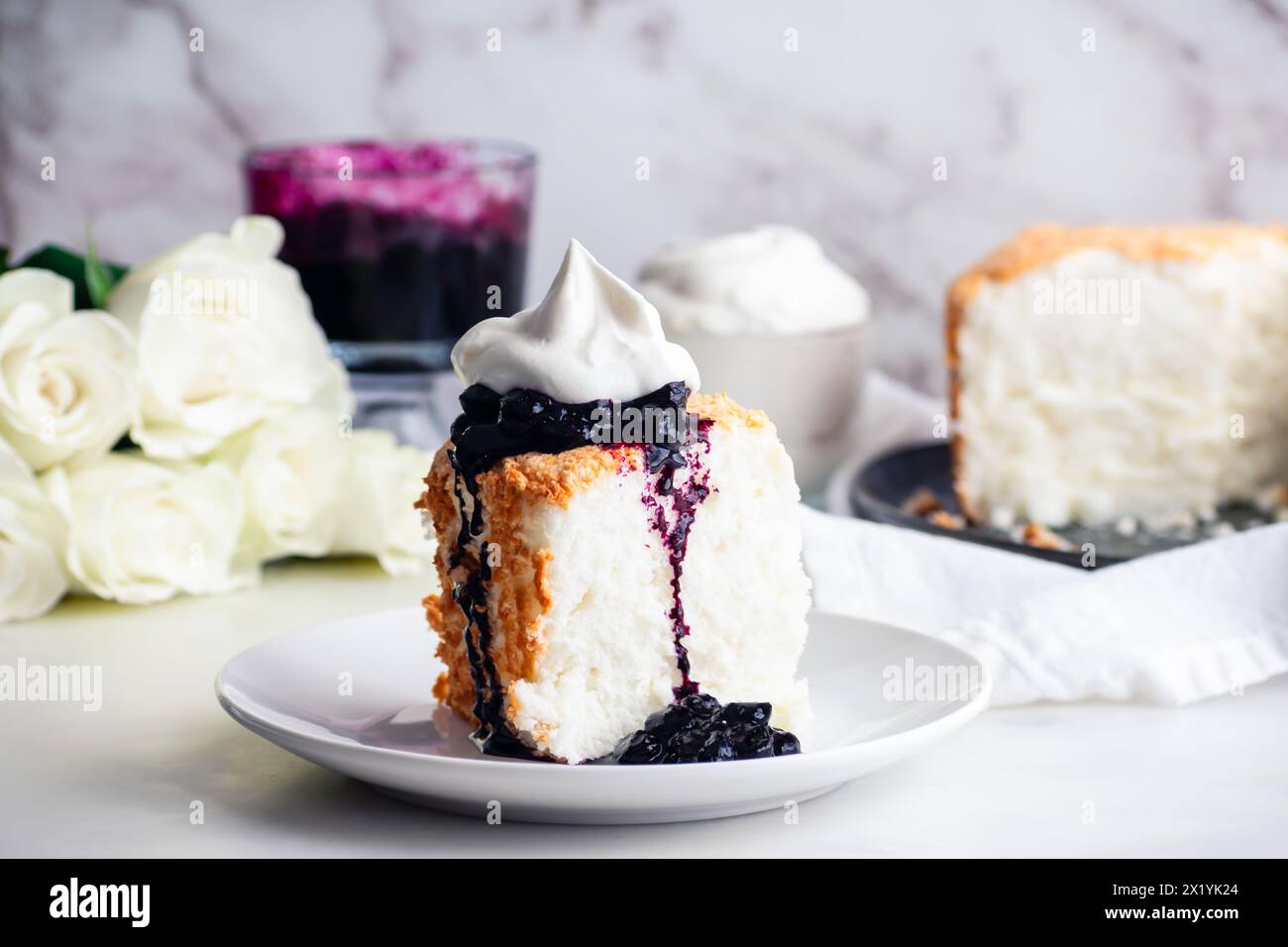 Angel Food Cake with Blueberry Sauce and Whipped Cream: Slice of sponge ...